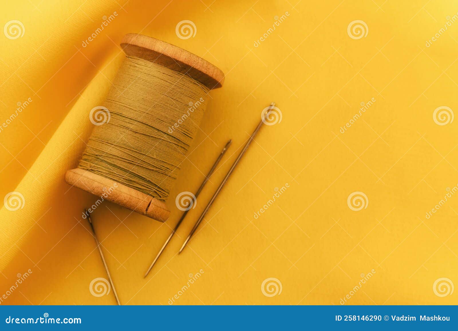 Old Retro Sewing Accessories Lie on a Yellow Fabric. Needle and Thread ...