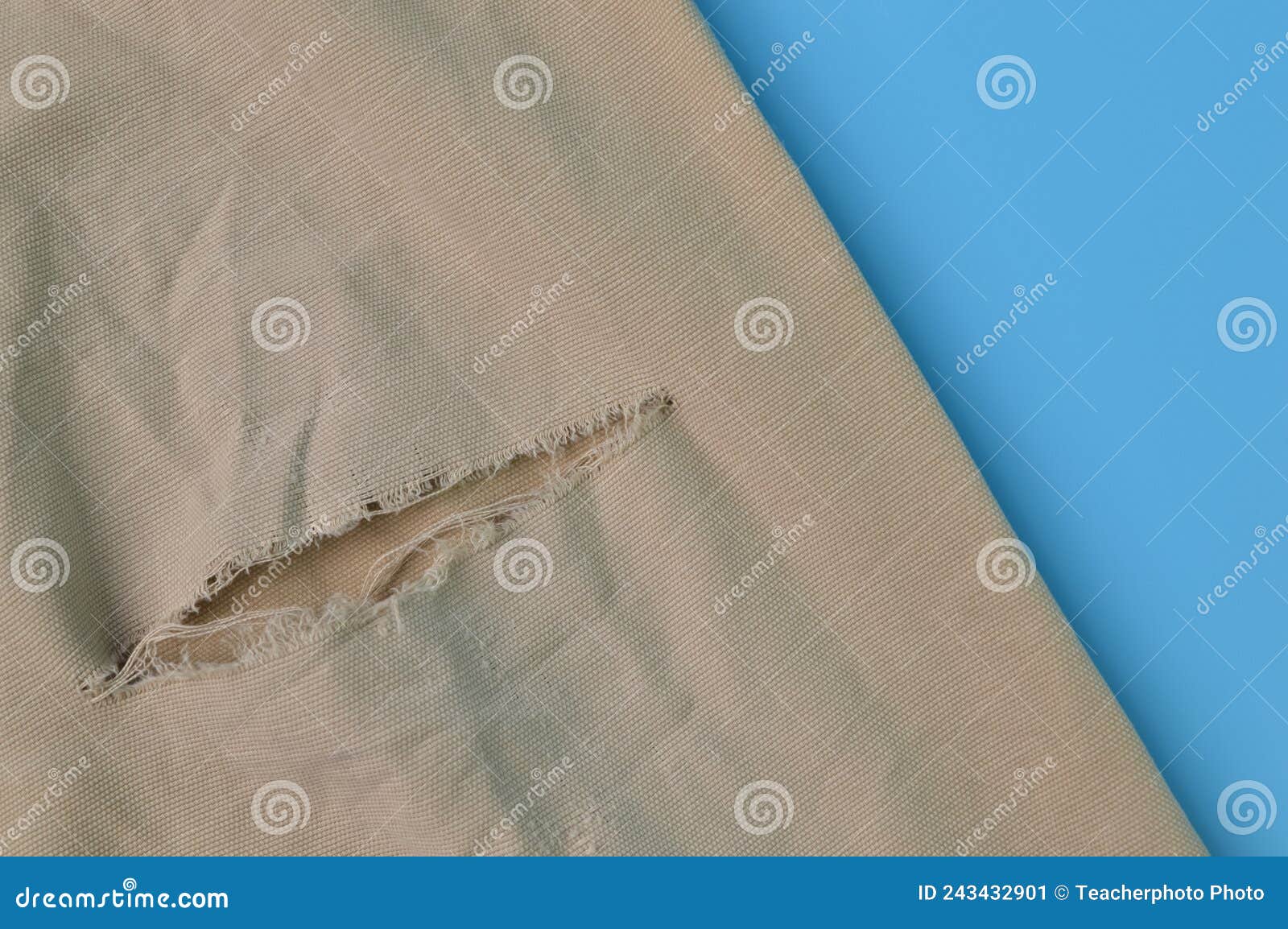 Old Ripped Fabric Man`s Pant Isolated on a Blue Background Stock Image ...