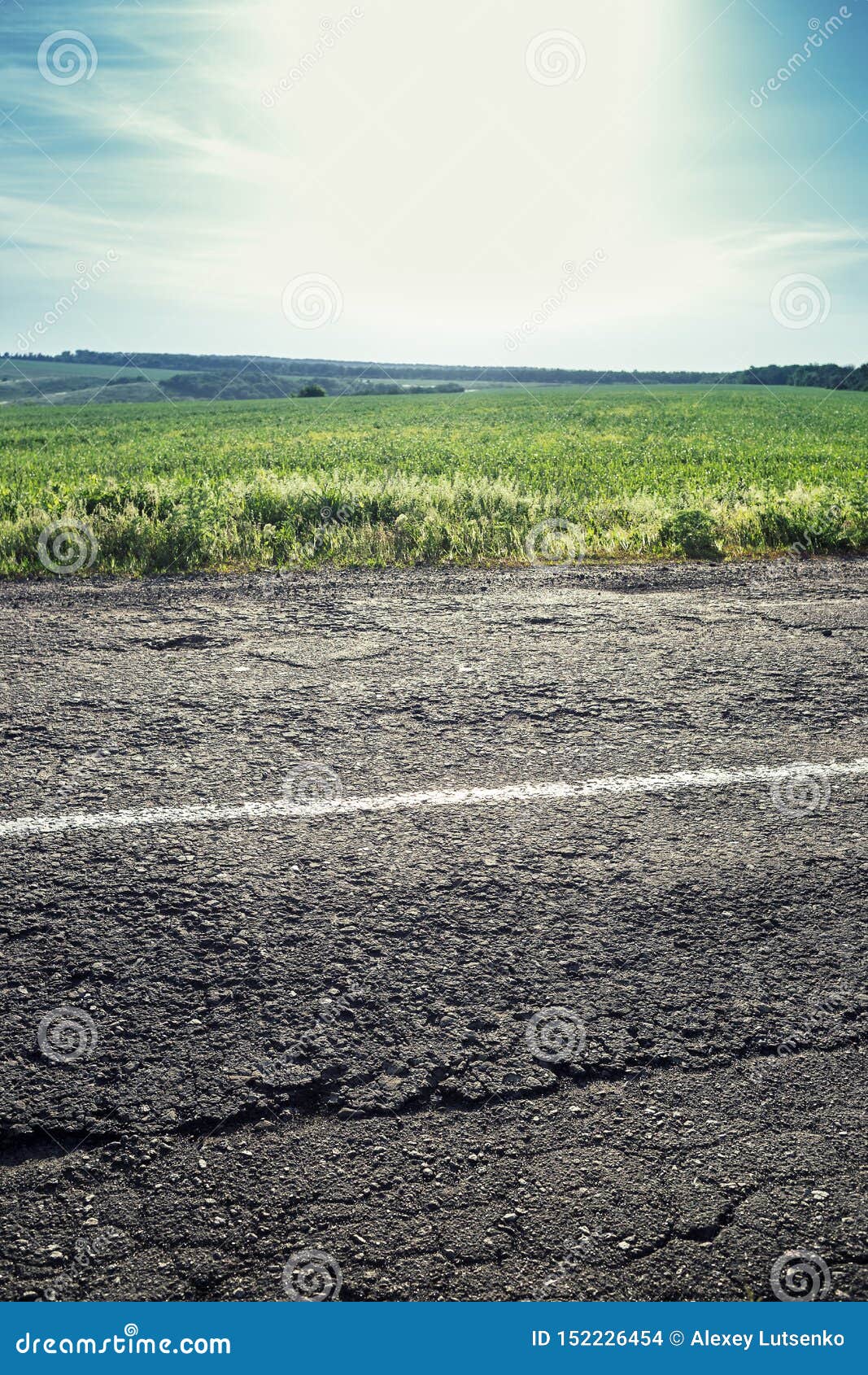 Old Road with a Dividing Strip, Grass and Sky in the Background Stock ...