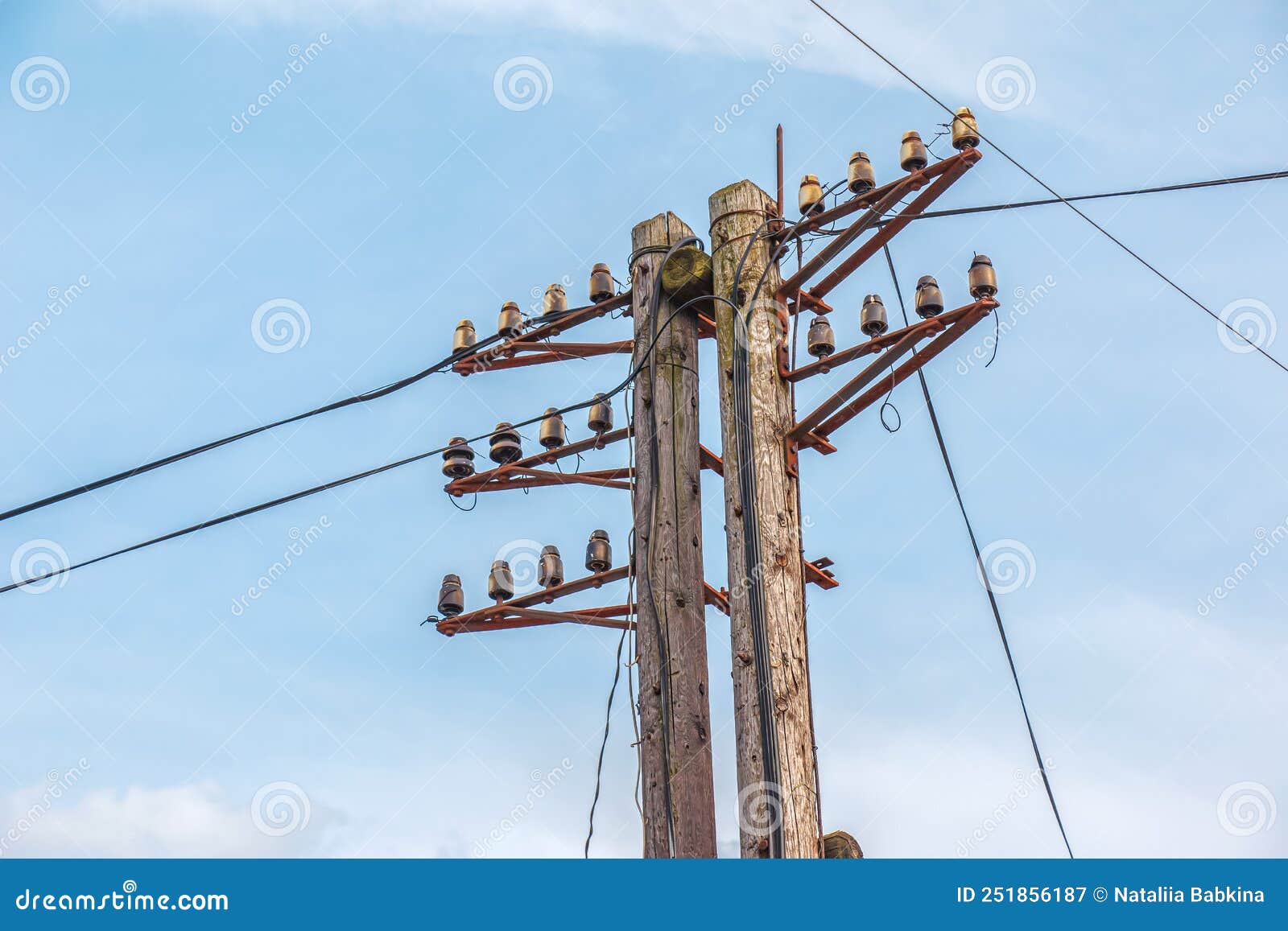 An Old, Rotten Wooden Pole with Electrical Insulators and Cut-off Wires ...