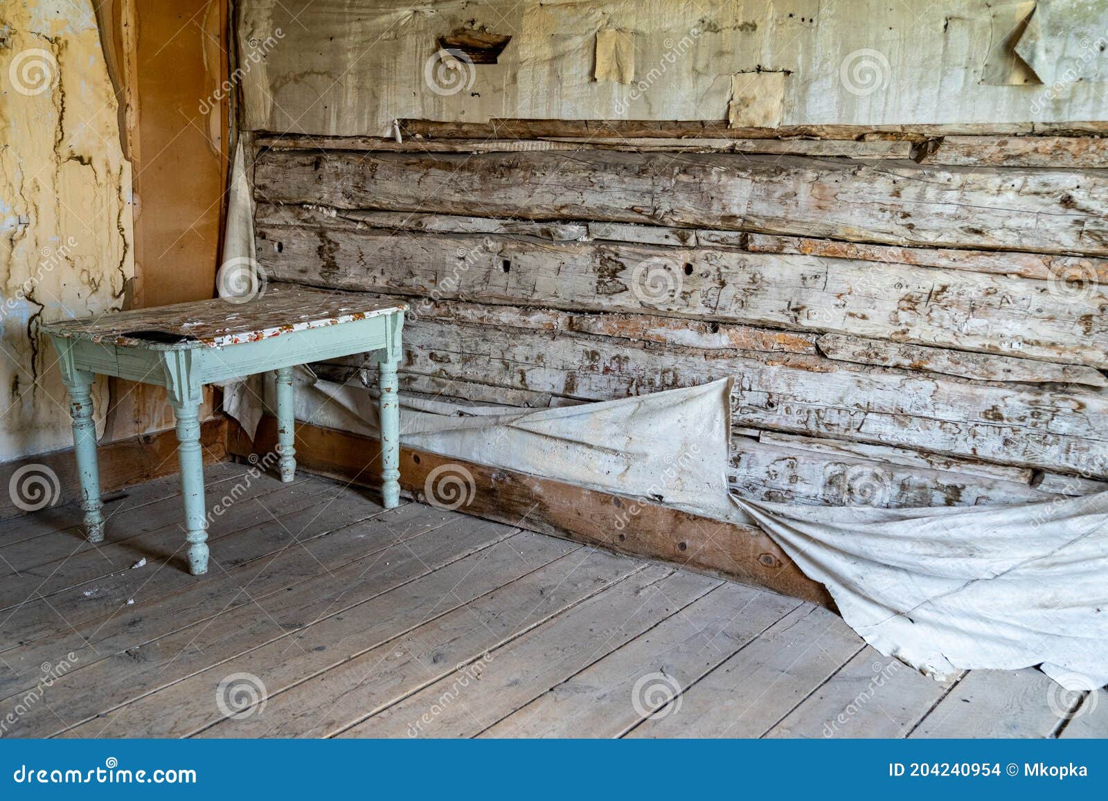 Old, Rotting Walls in an Abandoned Building with a Table Pushed in the ...