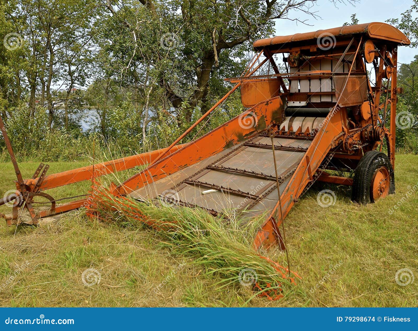 Old round orange hay baler stock photo. Image of memories - 79298674