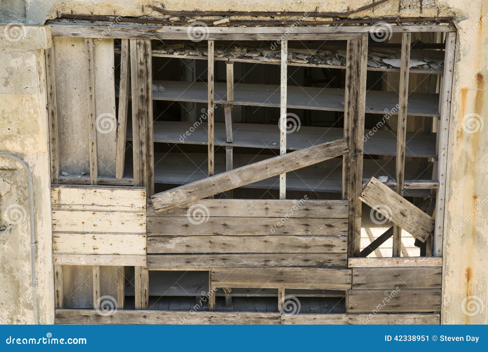 An Old Rundown Warehouse Wall With Two Wood Doors Royalty-Free Stock ...