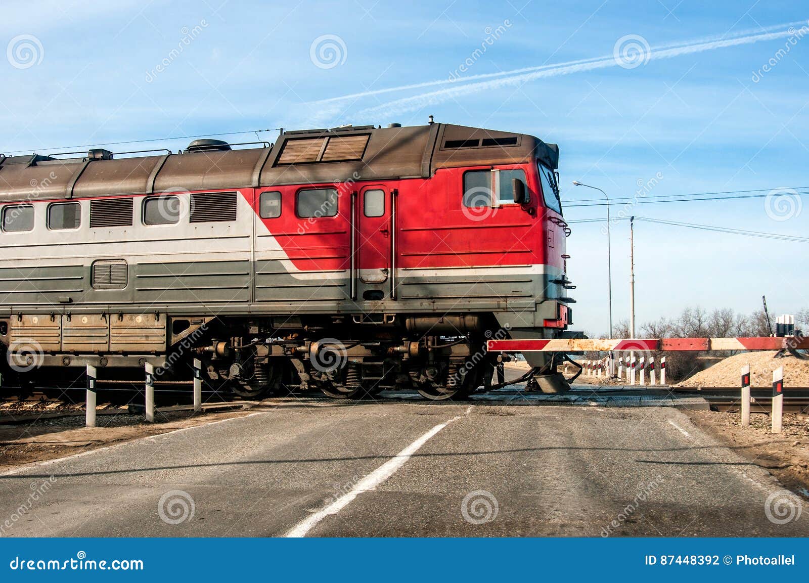An Old Russian Red Train Passing Across a Level Crossing, on a Small ...