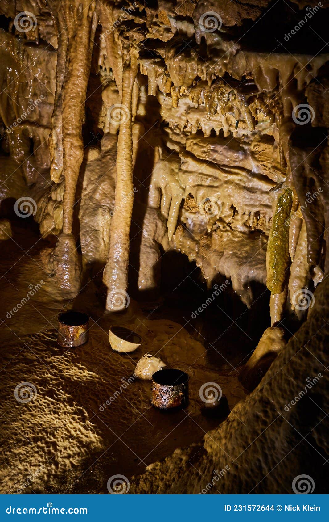 Old Rusted Drinking Cups on Ground of Cave Surrounded by Stalagmites ...