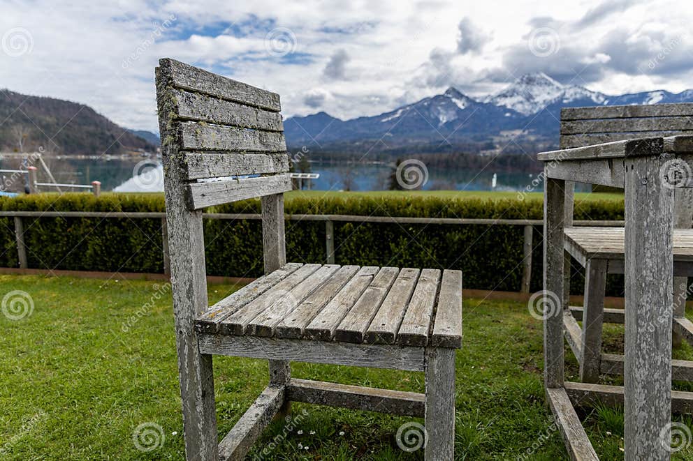 Old Rustic Chairs with a Table in Front of the Lake and the Alps Stock ...