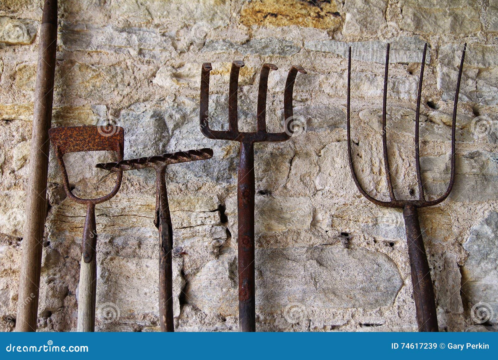 Old Rustic Tools Leaning Against a Stone Wall Stock Image - Image of ...