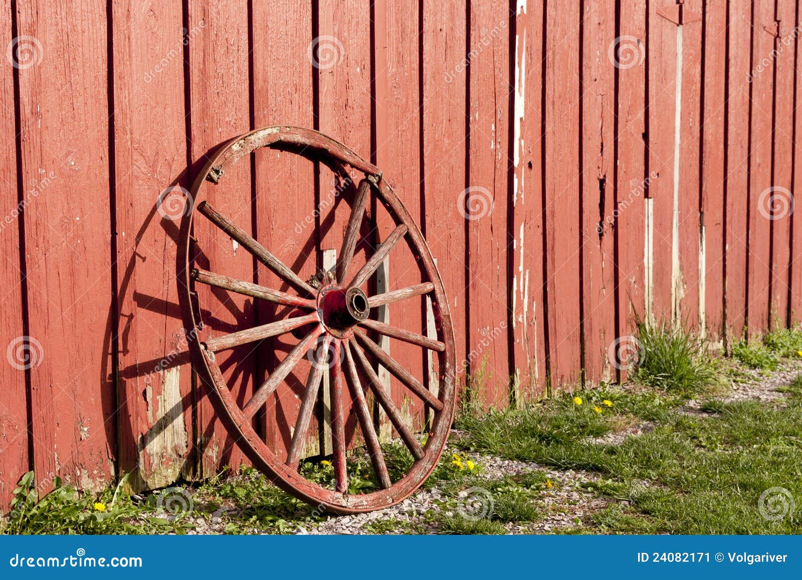 Old Rustic Wagon Wheel beside a Red Barn. Stock Image - Image of ...