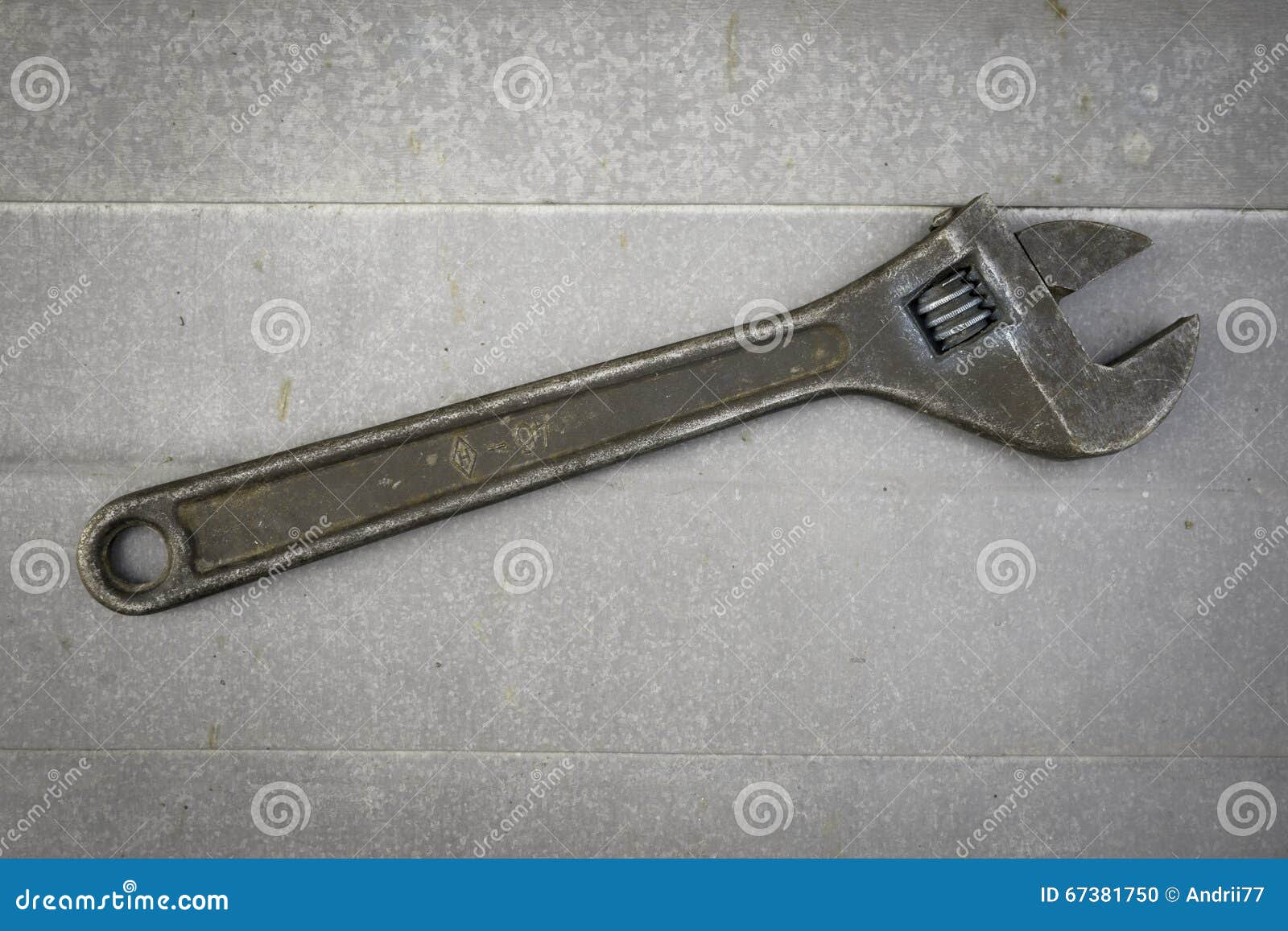 Old Rusty Adjustable Wrench on a Metal Background. Old Style. Stock ...