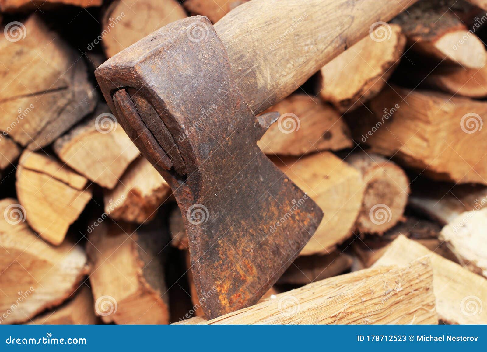 An Old Rusty Axe on the Background of a Stack of Firewood Stock Image ...