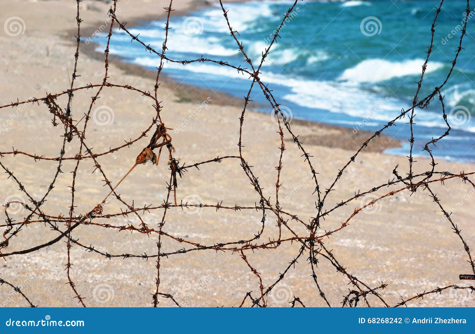Old Rusty Barbed Wire Fence on a Beach Stock Photo - Image of blue ...