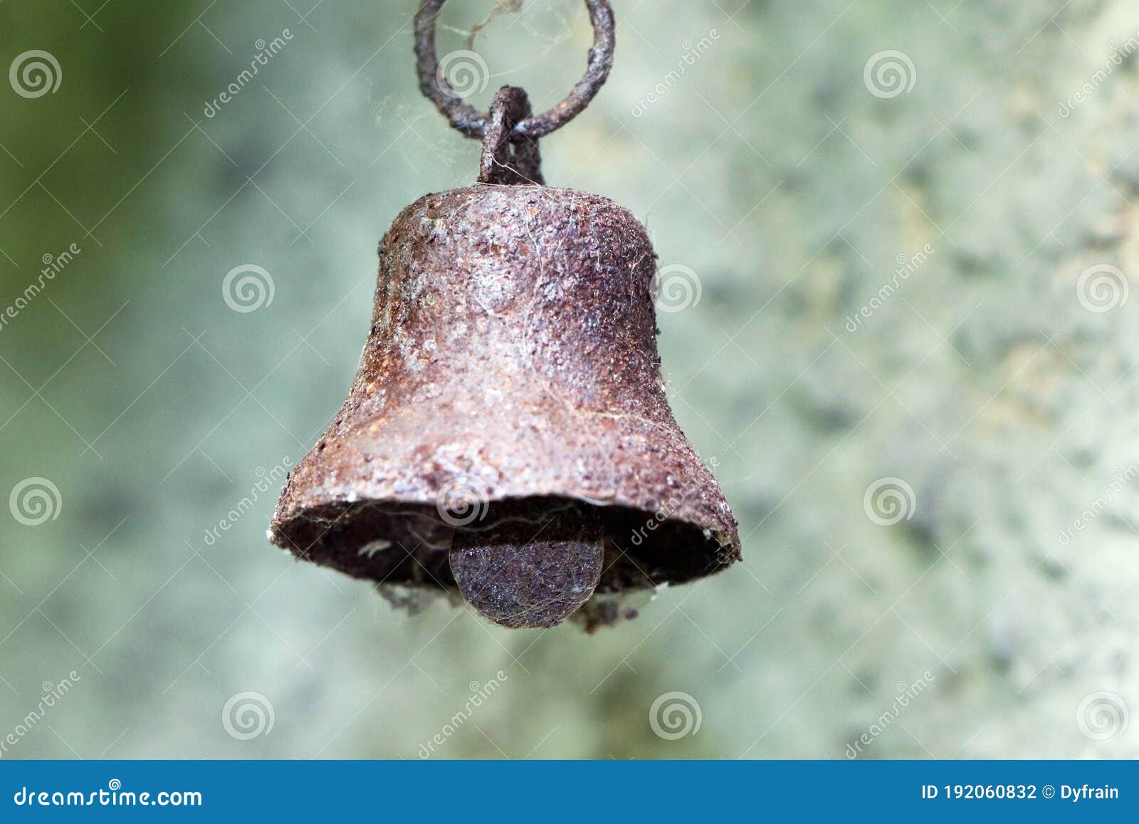 An Old Rusty Bell in a Web . Iron Bell on Concrete Wall Stock Photo ...