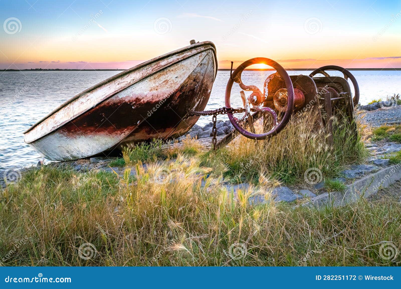 Old Rusty Boat on the Grassy Shore of a Lake during the Sunrise Stock ...