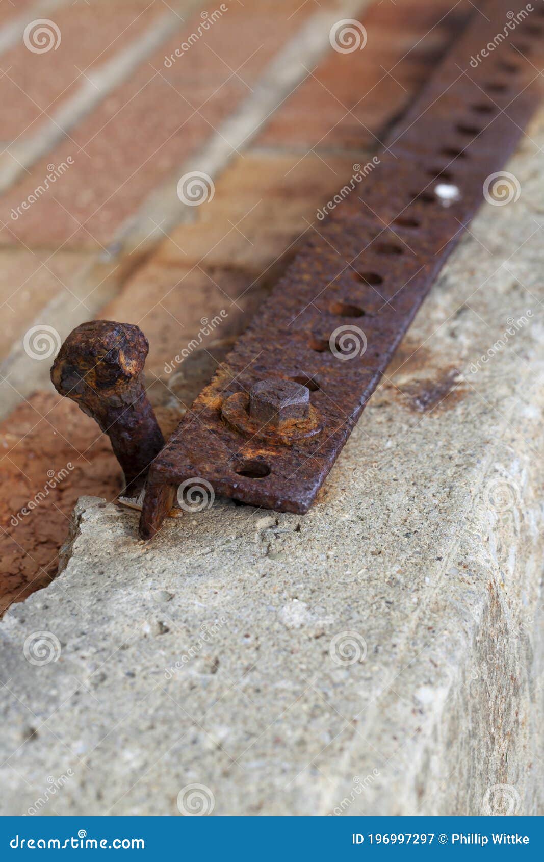 An Old Rusty Bolt and Metal Angle Iron Section on Broken Concrete Stock ...