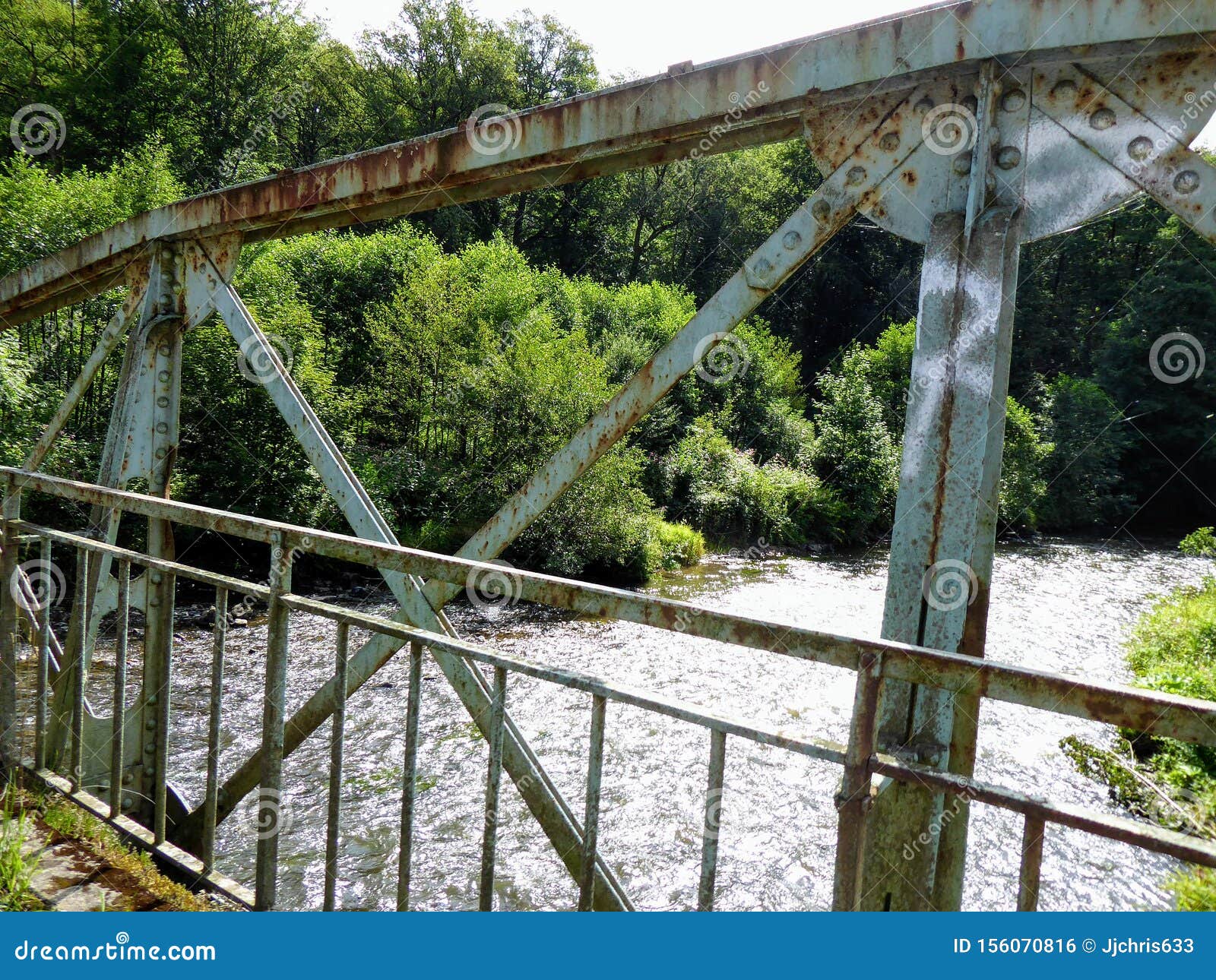 Old Rusty Bridge Over Creek Water. Forest River with Old Bridge Stock ...