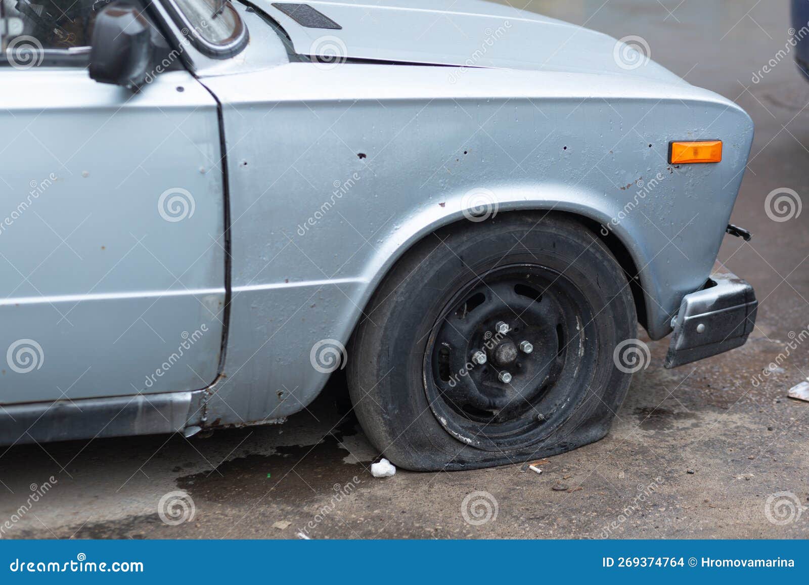 An Old Rusty Car with a Punctured Front Wheel Stock Photo - Image of ...