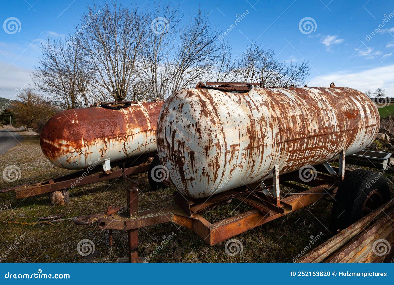 Old Rusty Cisterns in a Field during Autumn Stock Photo - Image of tank ...