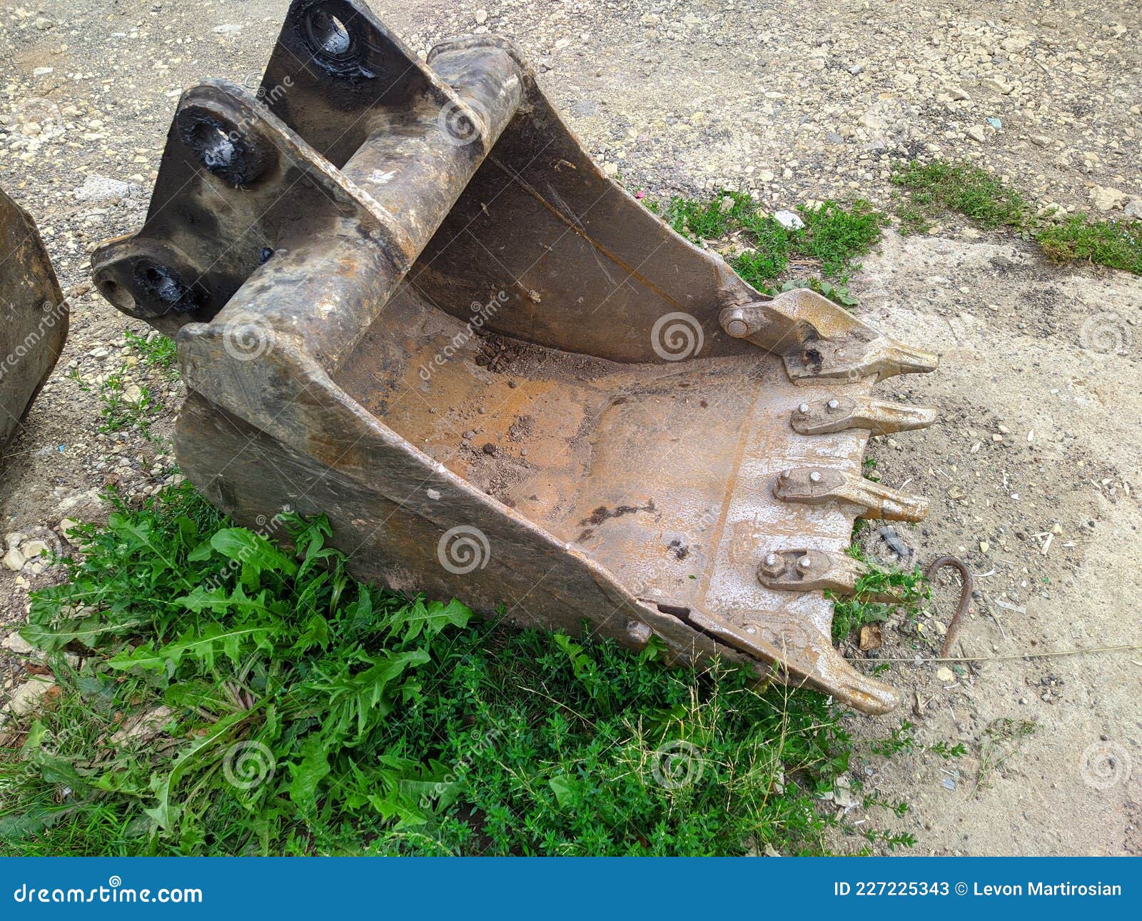 Old and Rusty Dirty Digger Excavator Bucket on the Street. Stock Image ...