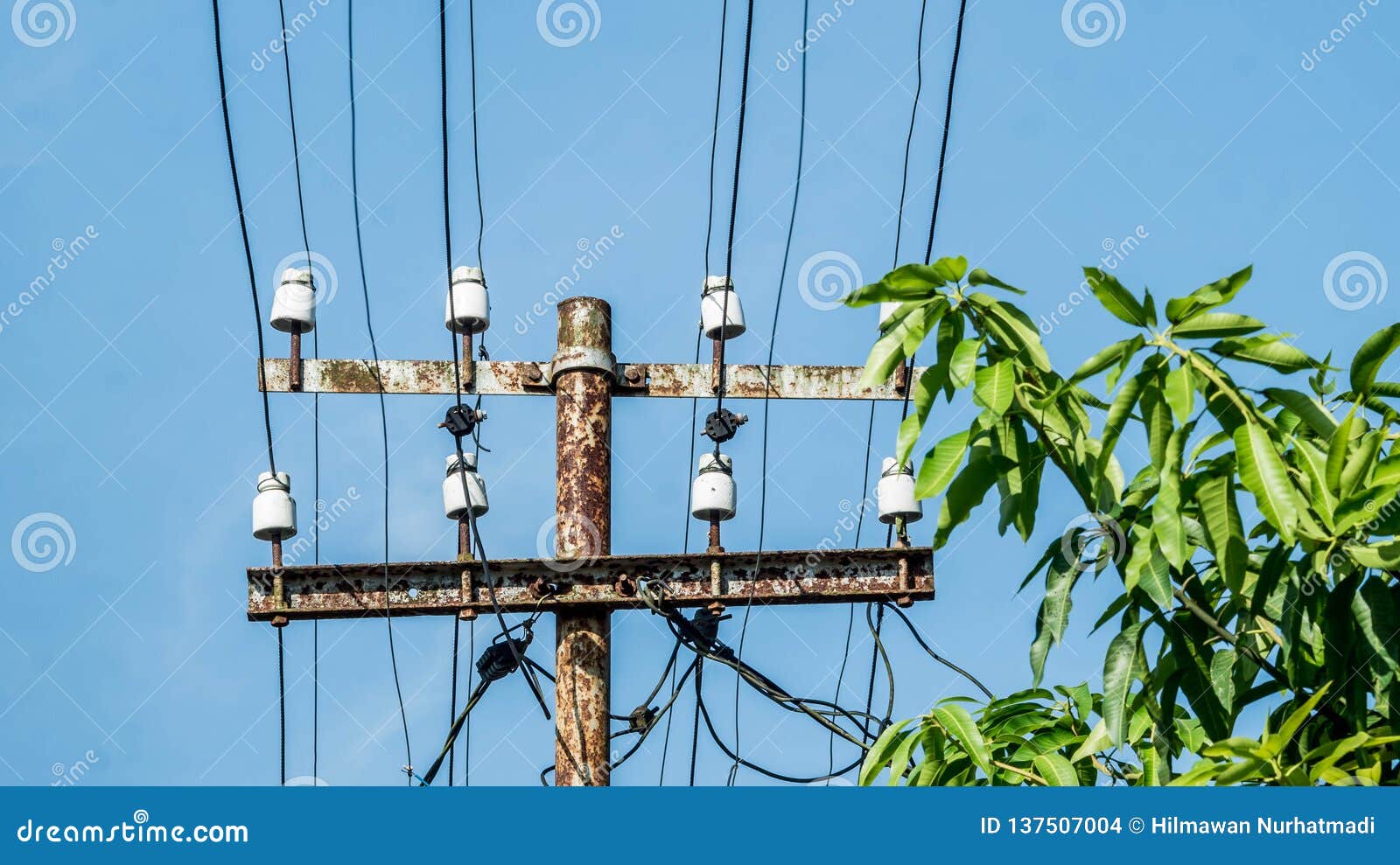 Old Rusty Electrical Pole with Many Wires and Transformers Near the ...