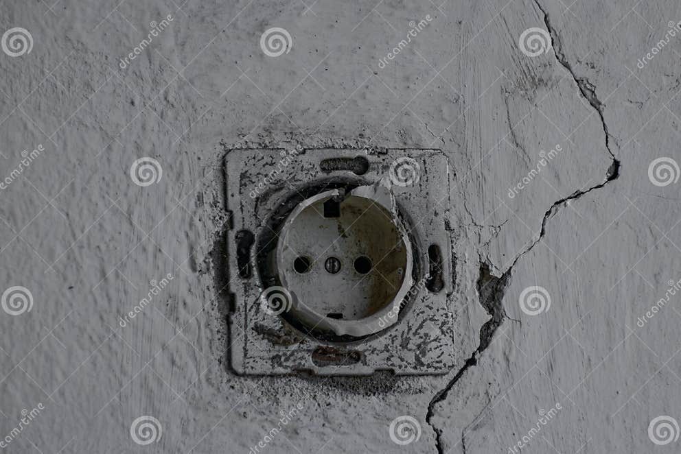 Old Rusty Electrical Socket on a Cracked White Wall. Stock Image ...