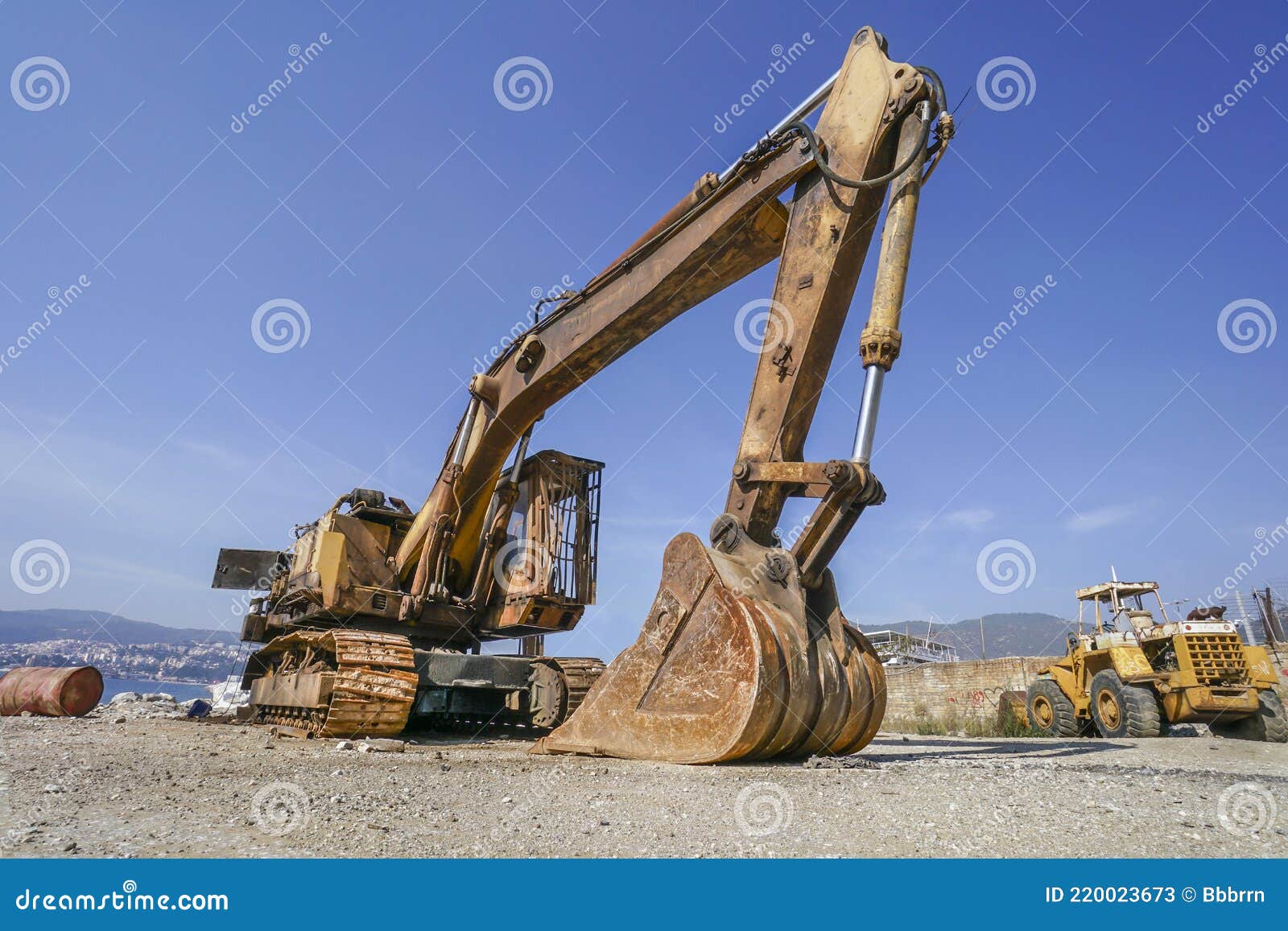 An Old and Rusty Excavator in a Construction Site Stock Image - Image ...