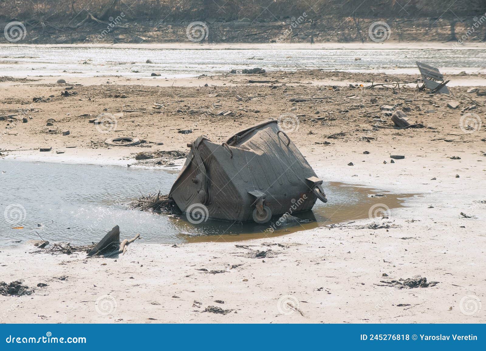 Old Rusty Garbage Bin Tipped Over Polluting the Water Stock Photo ...