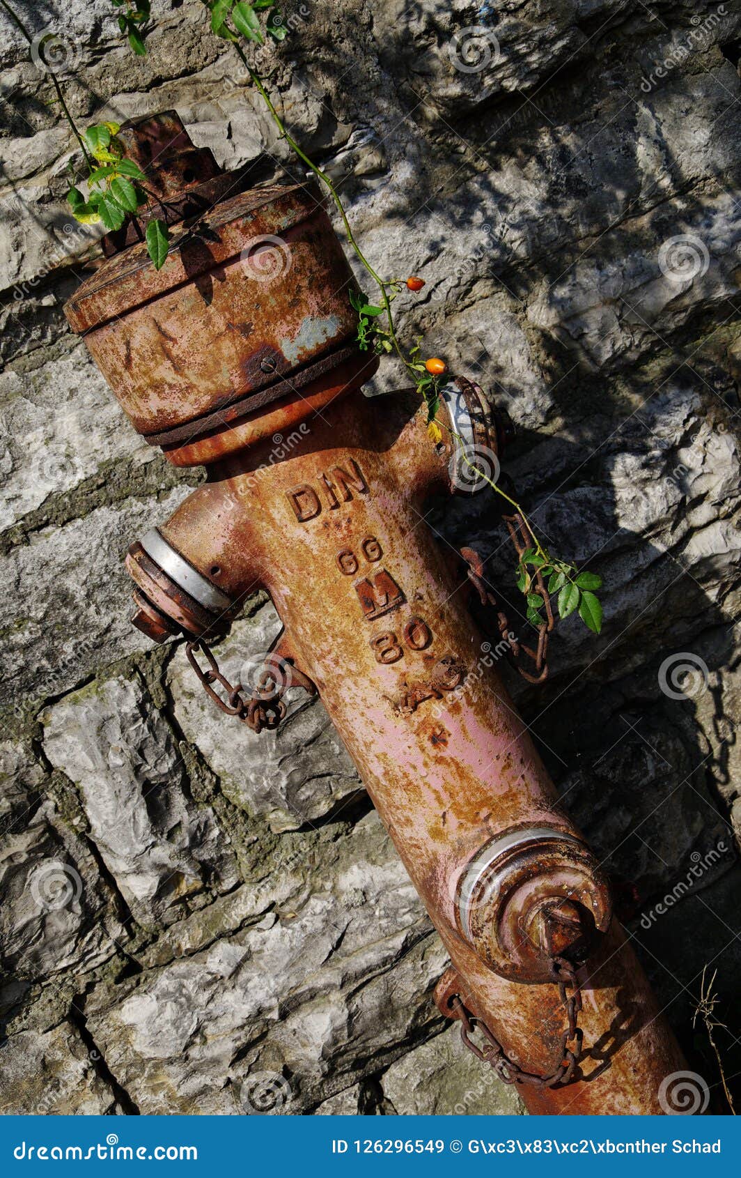 Old Rusty Hydrant in Front of Natural Stone Wall in an Oblique Camera ...