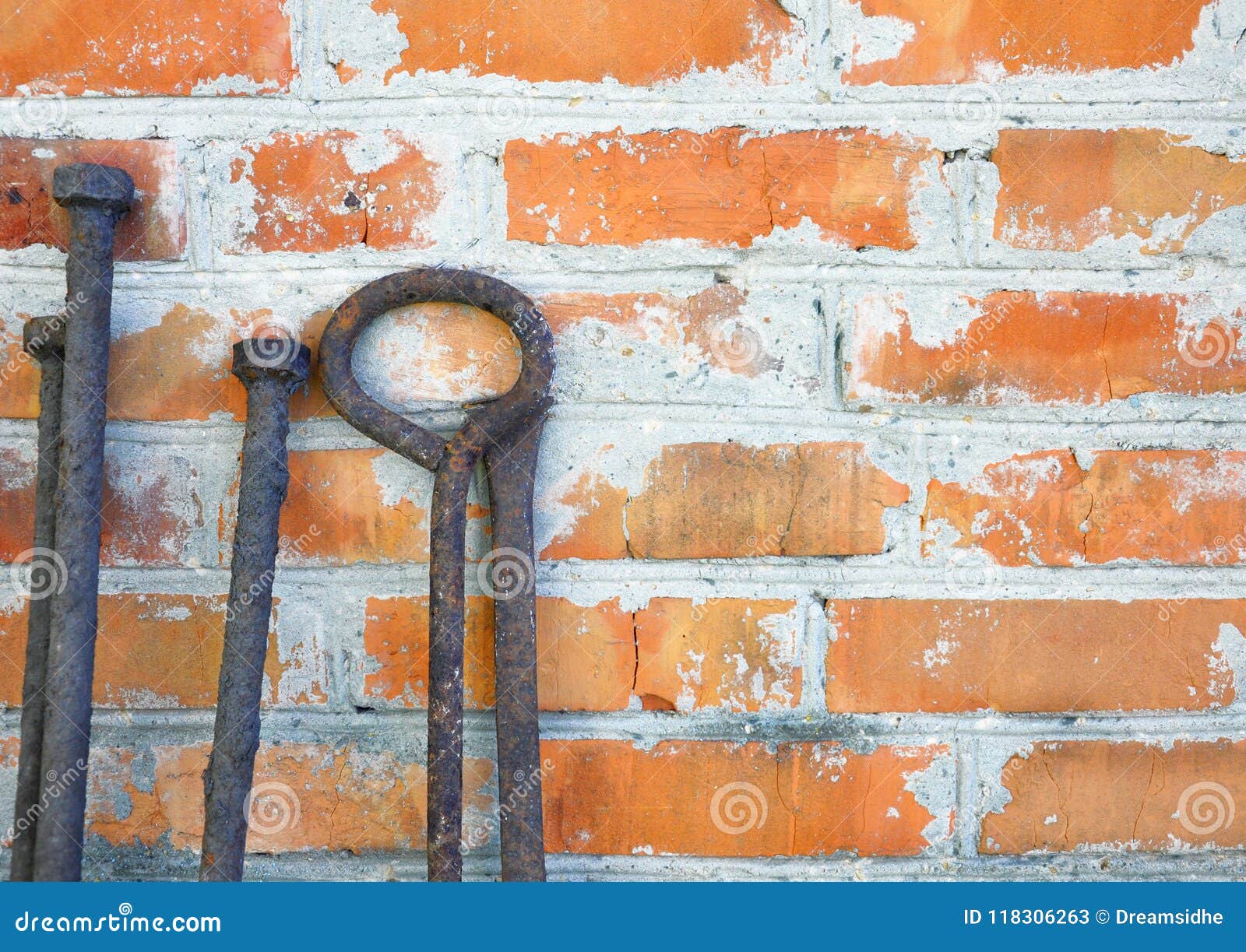 Old Rusty Iron Scrap Standing on the Background of a Brick Wall Stock ...