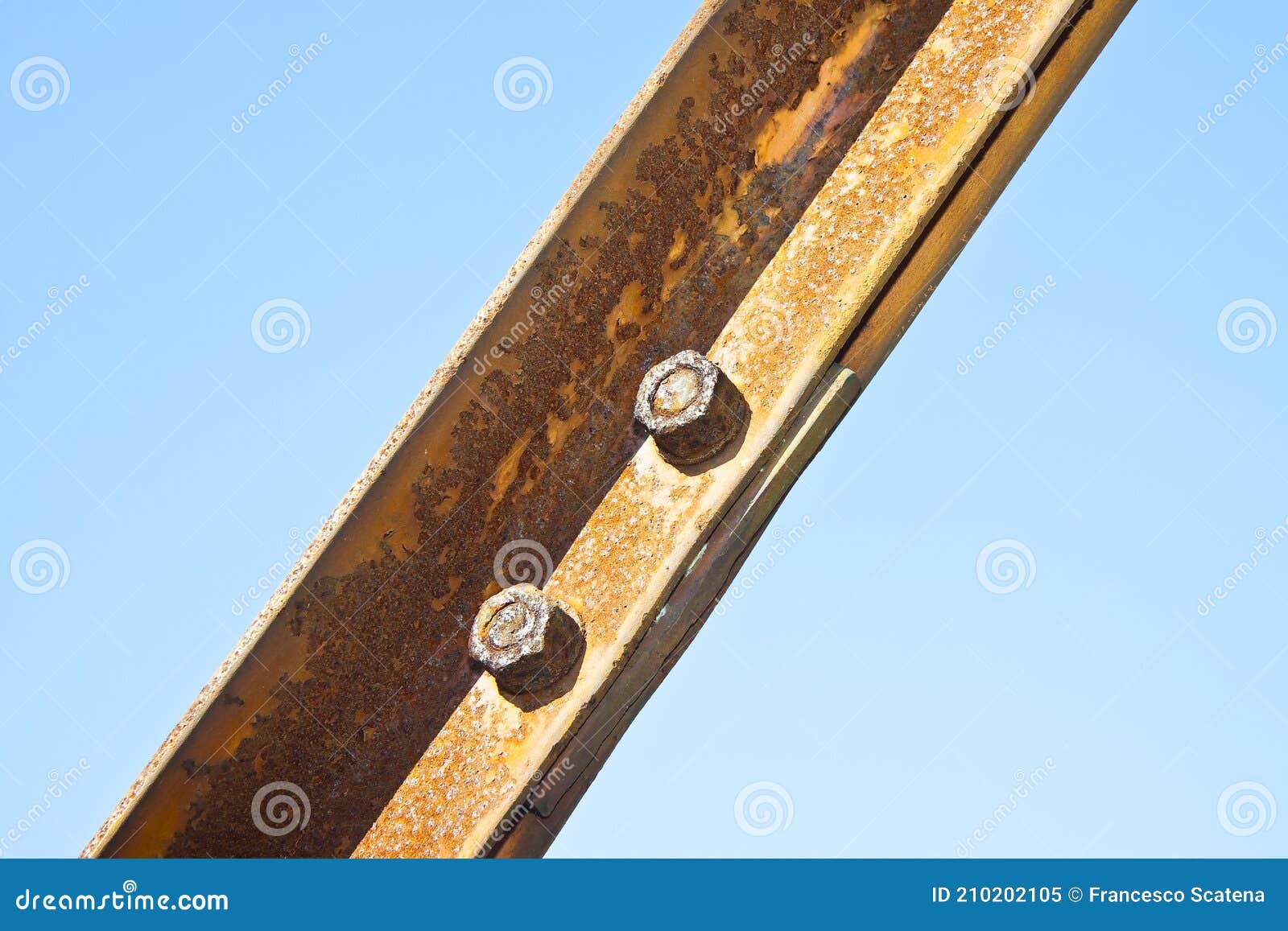 Old Rusty Iron Structure with Bolted Metal Profiles Against a Blue Sky ...
