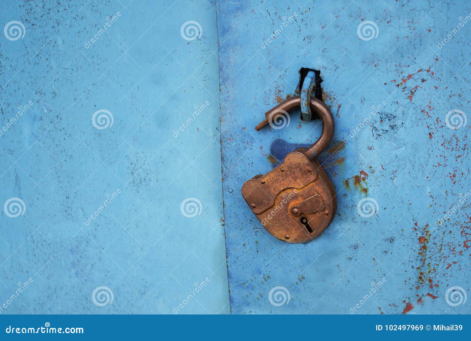 Old Rusty Lock with a Key on a Blue Background Stock Image - Image of ...