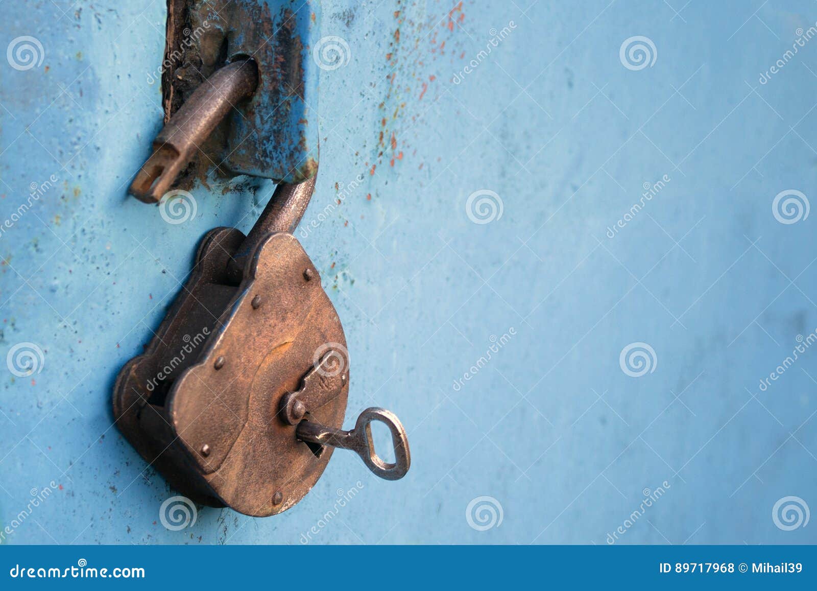 Old Rusty Lock with a Key on a Blue Background Stock Photo - Image of ...