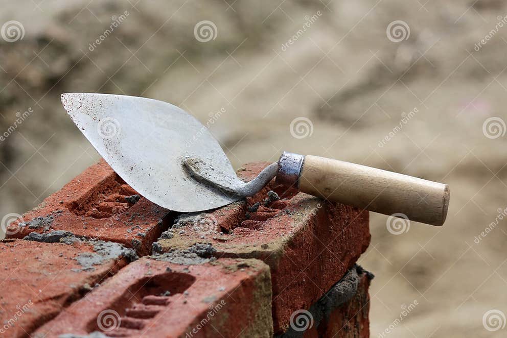 Old Rusty Masonry Trowel Mason Tool on Bricks Work Under Construction ...