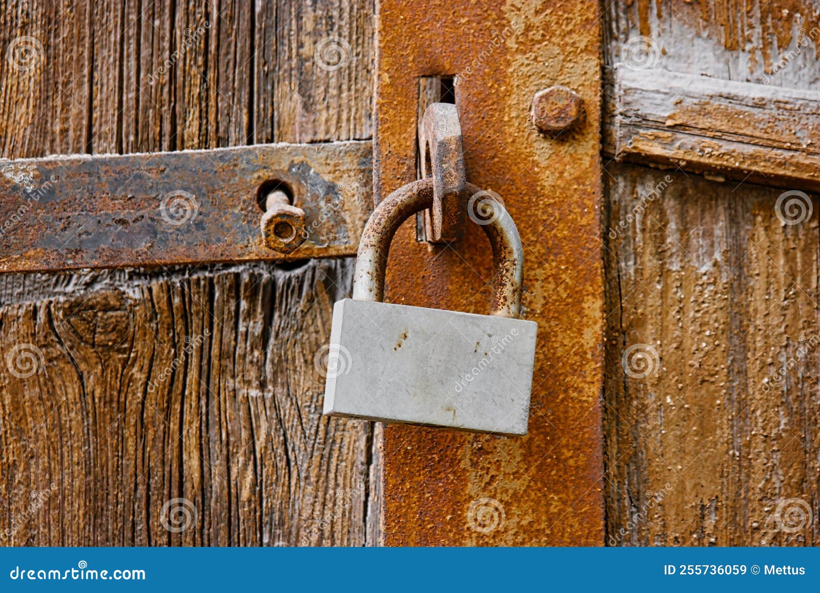 Old Rusty Padlock on Wooden Gates. an Obsolete Lock Hangs on the ...