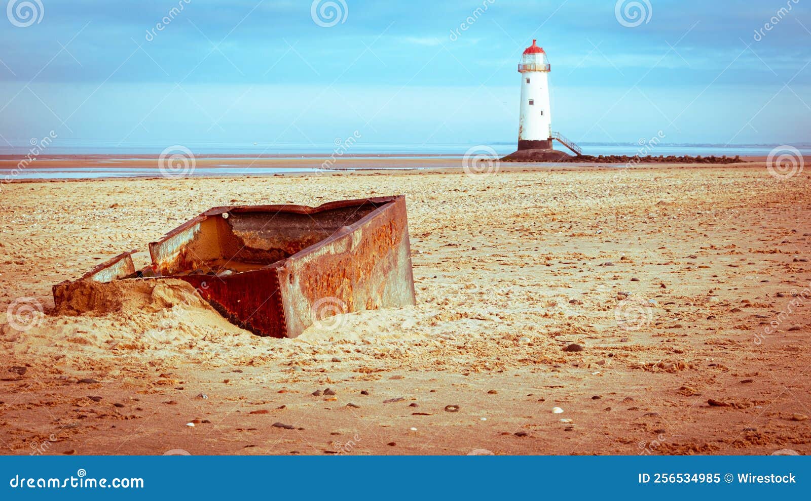 Old Rusty Piece of Metal on an Empty Sandy Beach with a Lighthouse ...