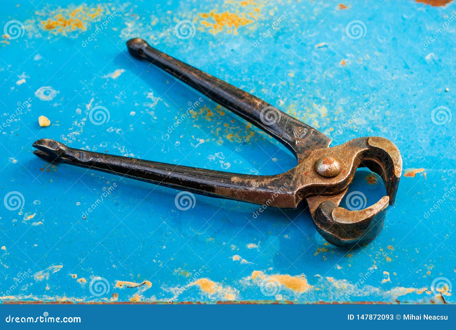 Old Rusty Pincers on a Blue, Rusty Metal Background. First-class Levers ...