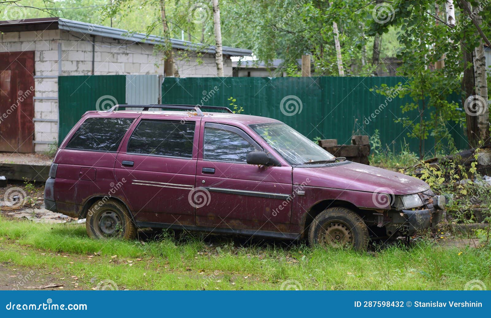 An Old Rusty Red Car Abandoned at the Fence Stock Photo - Image of ...