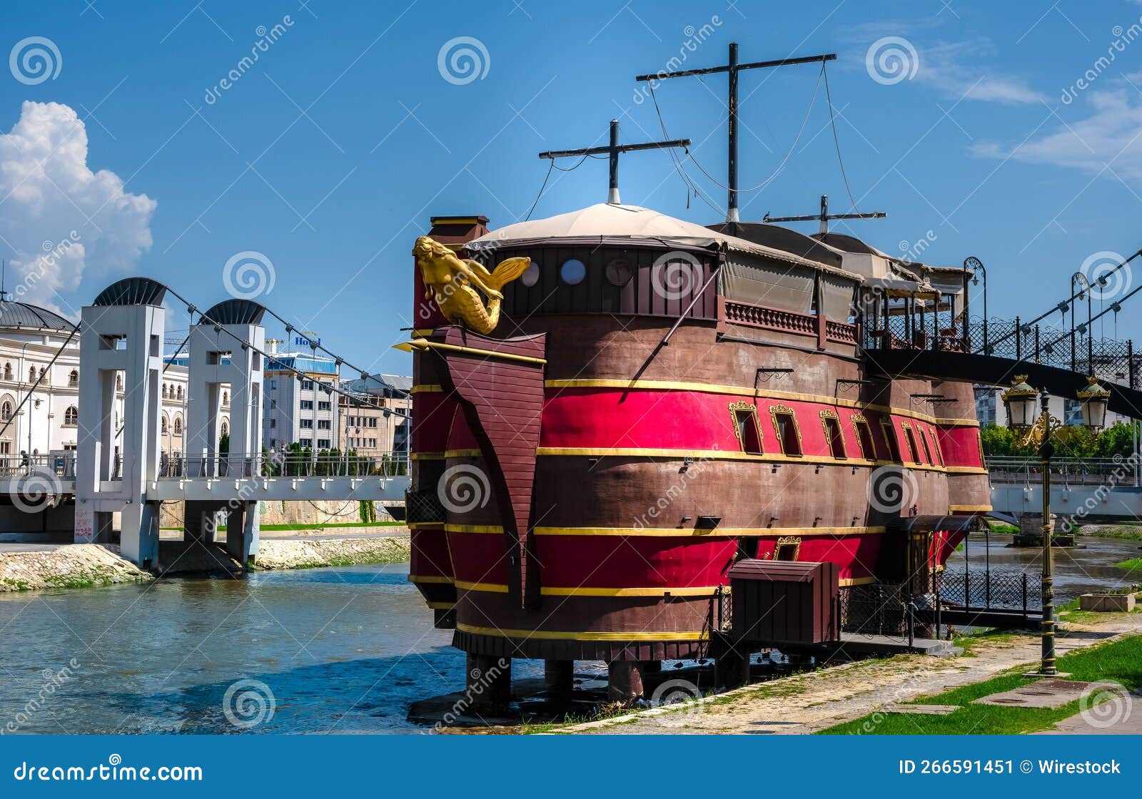 Old Rusty Ship on the Vardar River with a Bridge and Buildings in the ...