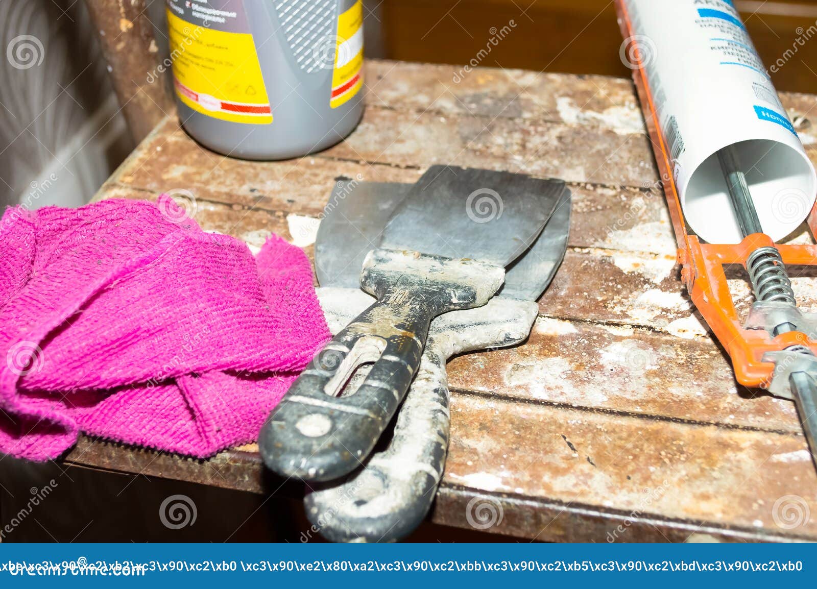 On an Old Rusty Step-ladder There is a Sealant Gun, Glue, Rag, Spatulas ...