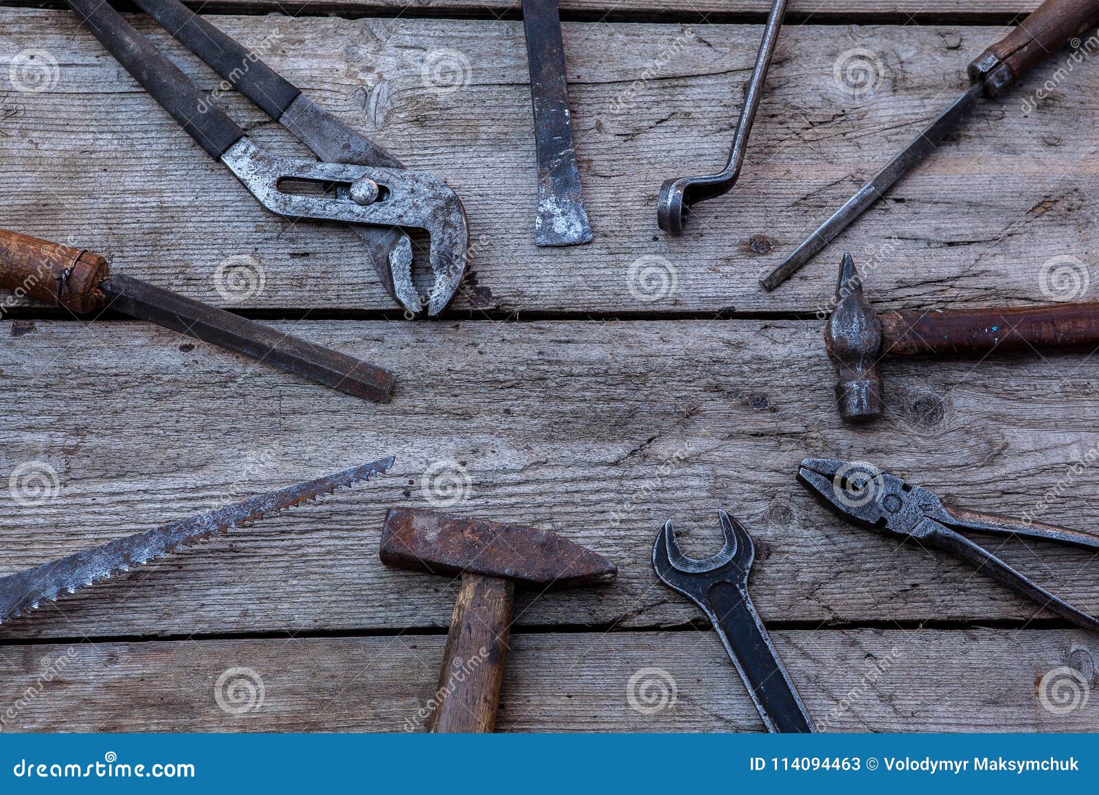 Old, Rusty Tools Lying on a Black Wooden Table. Hammer, Chisel, Hacksaw ...