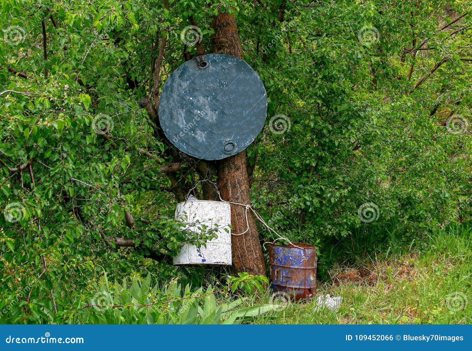Old and Rusty Trash Containers for Garbage. Trash Bin Along the Stock ...