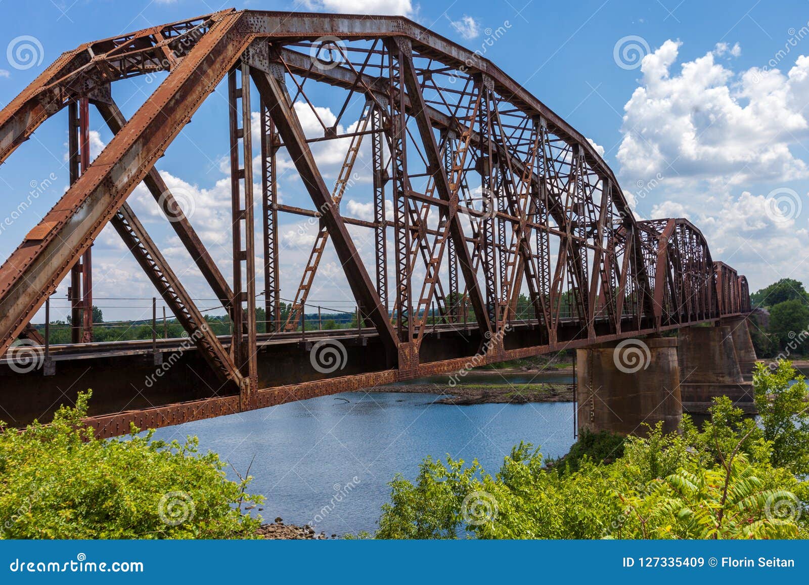 Old Rusty Truss Bridge With Moving Freight Train Over The Red Ri ...