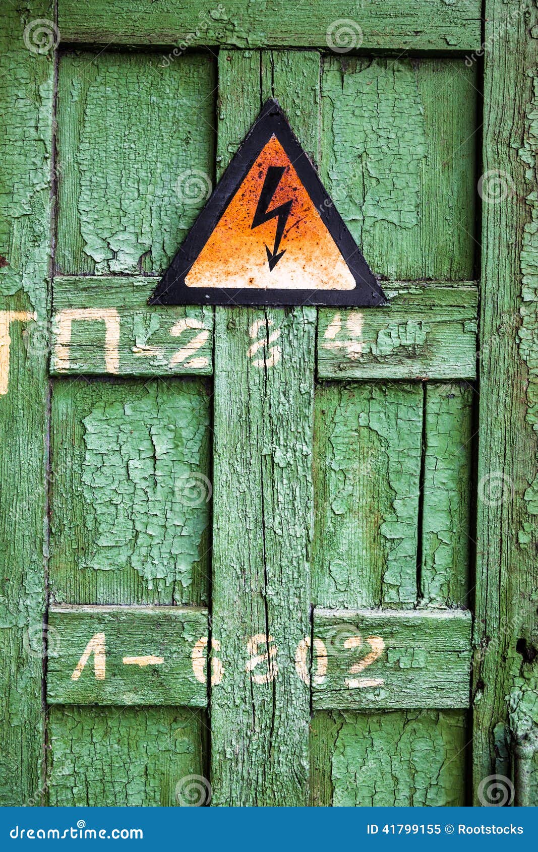 Old Rusty Warning High Voltage Sign on Cracked Wooden Surface Stock ...