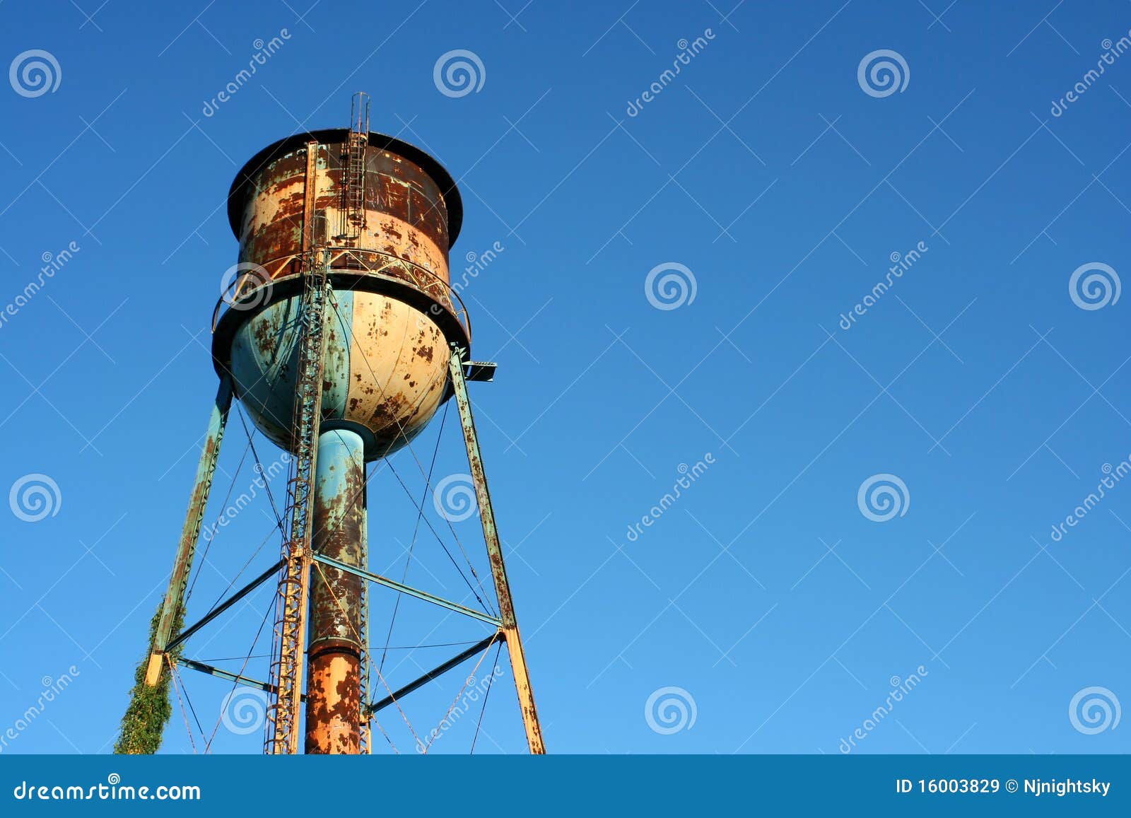 Old Rusty Watertower Against Blue Sky Stock Image - Image of watertower ...