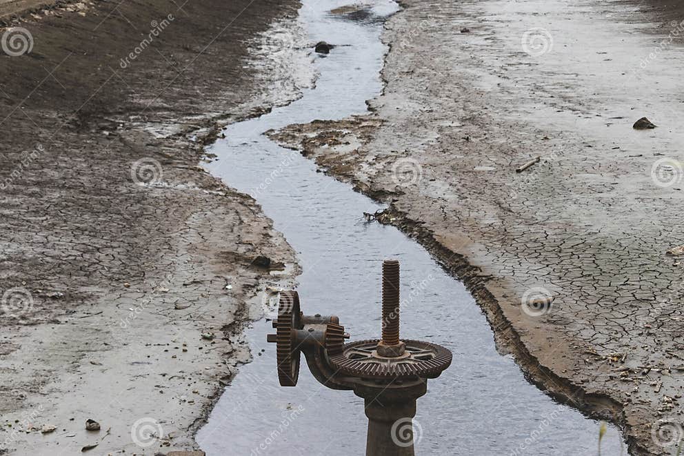 Old and Rusty Wheel of a Control Valve with a Waterway in the ...