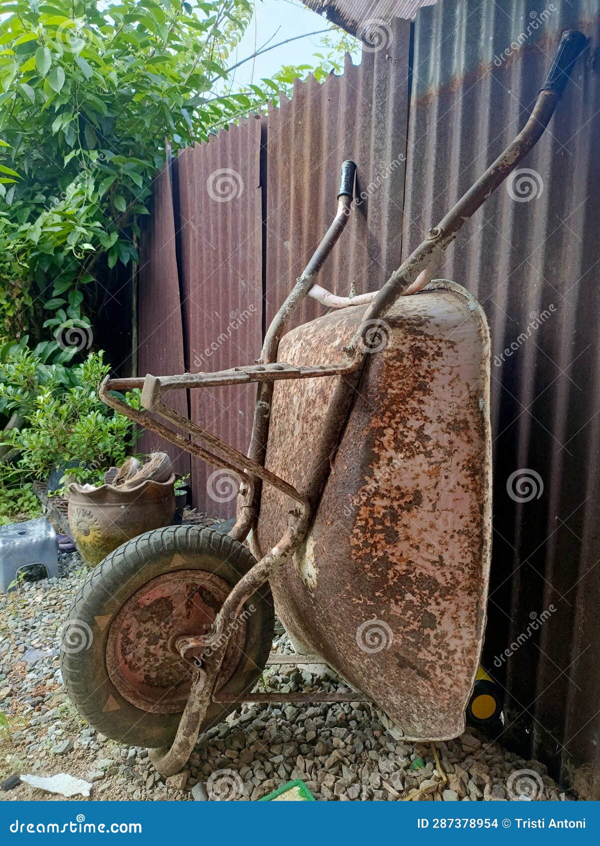 Old and rusty wheelbarrow stock photo. Image of wheelbarrow - 287378954