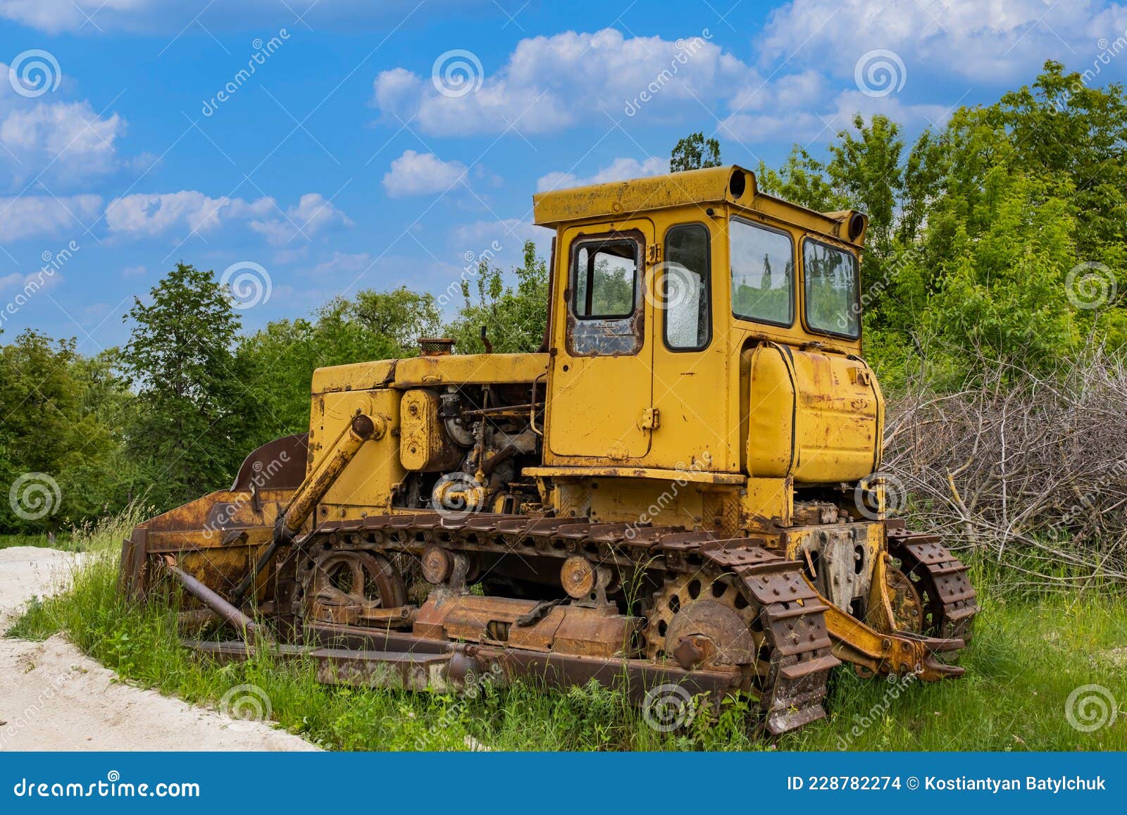 An Old Rusty Yellow Crawler Bulldozer is Standing in the Forest Stock ...