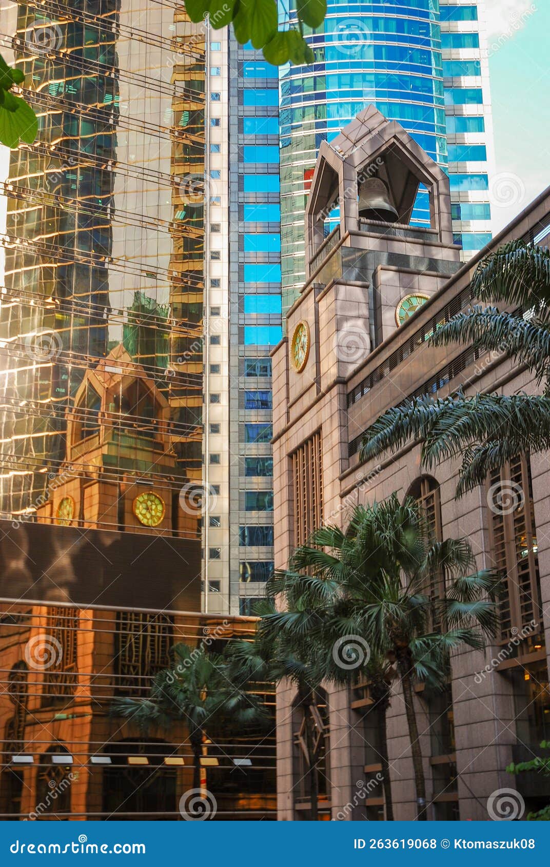 An Old Sandstone Building with a Bell Tower is Reflected in the Windows ...
