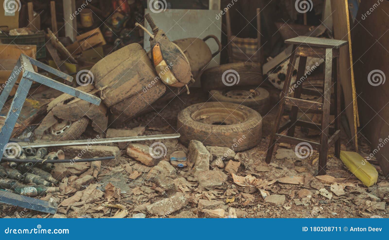 An Old Scooter is Lying in a Dump. a Lot of Old Junk in the Dust and ...