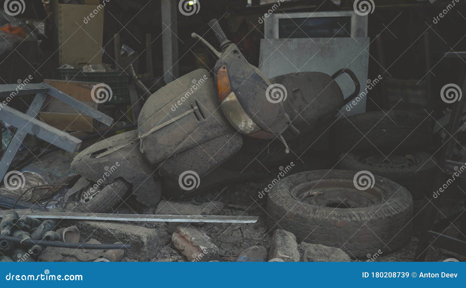 An Old Scooter is Lying in a Dump. a Lot of Old Junk in the Dust and ...