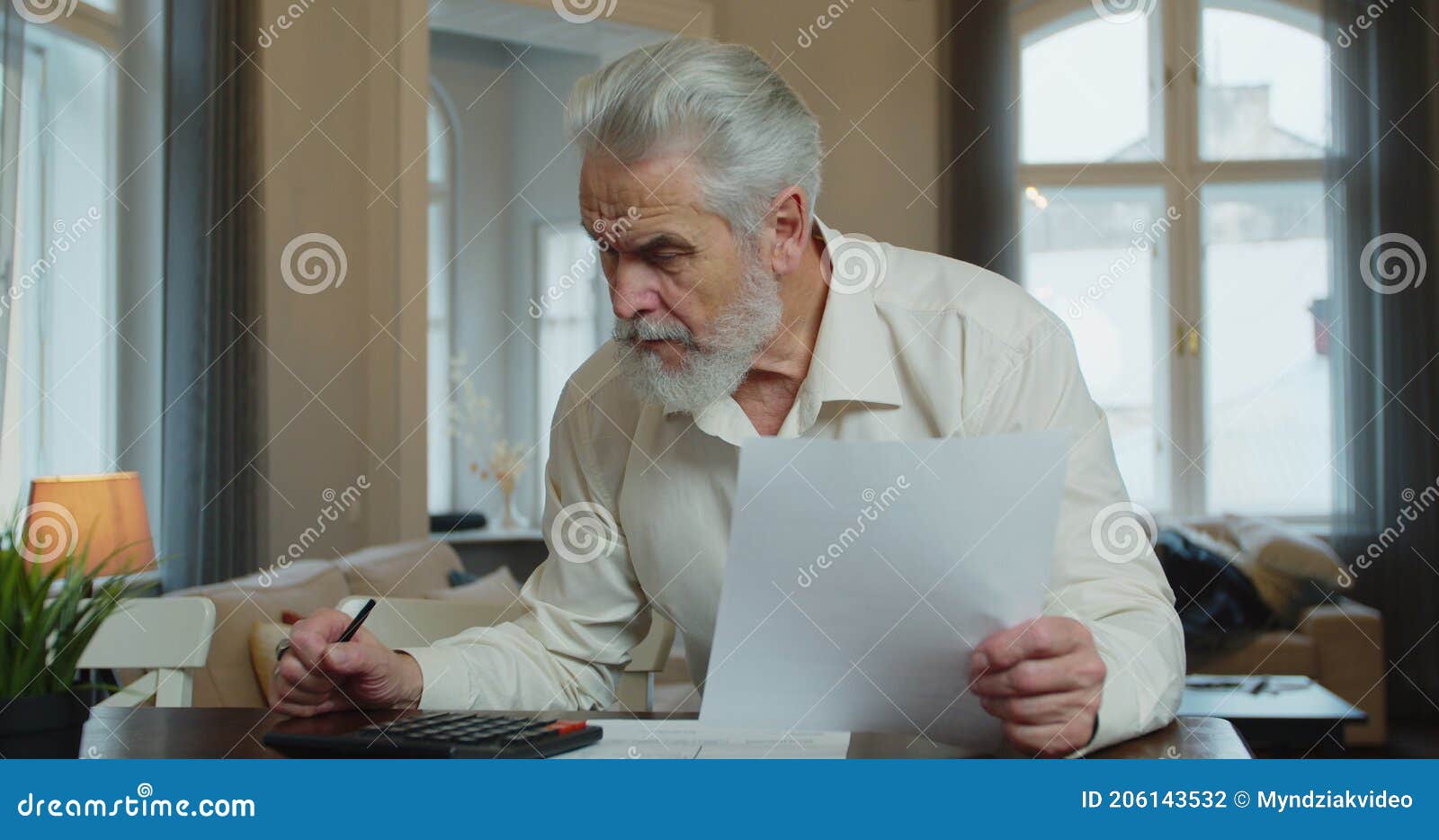 Old Senior Man Checking Home Finances and Bills, he is Calculating ...